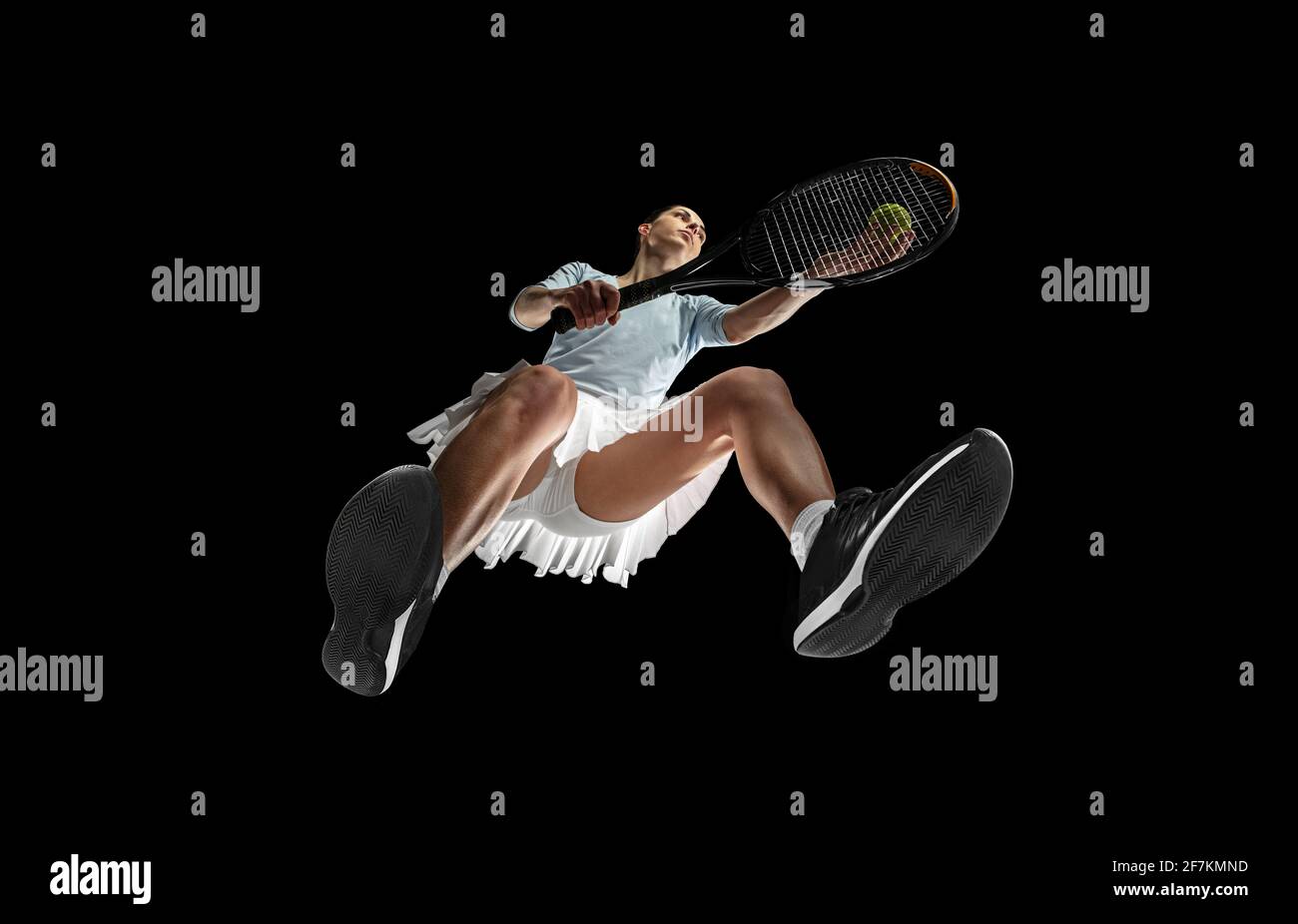Female professional tennis player in action, motion isolated on black ...