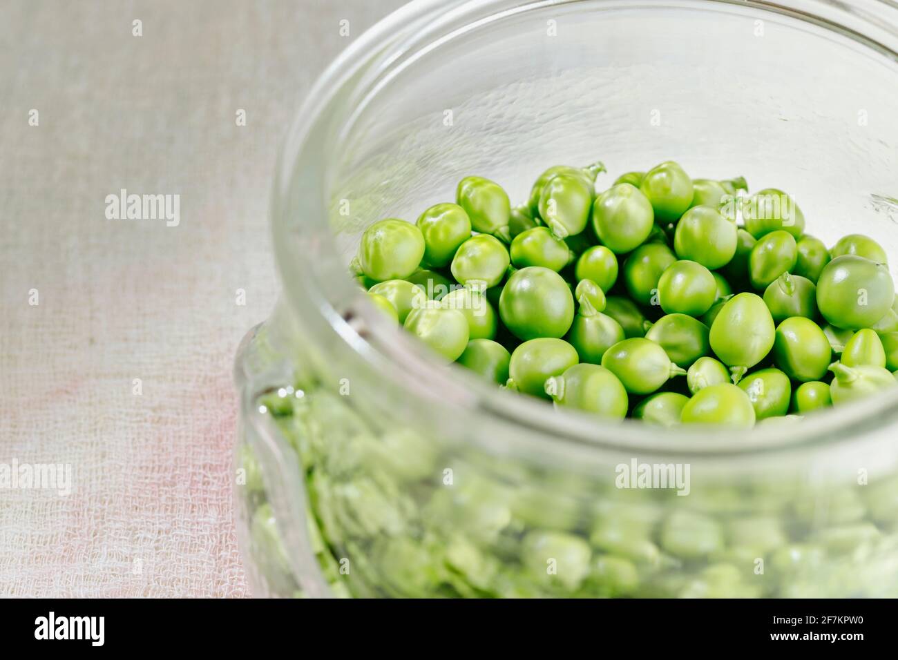 Fresh uncooked green peas in glass bowl Stock Photo - Alamy