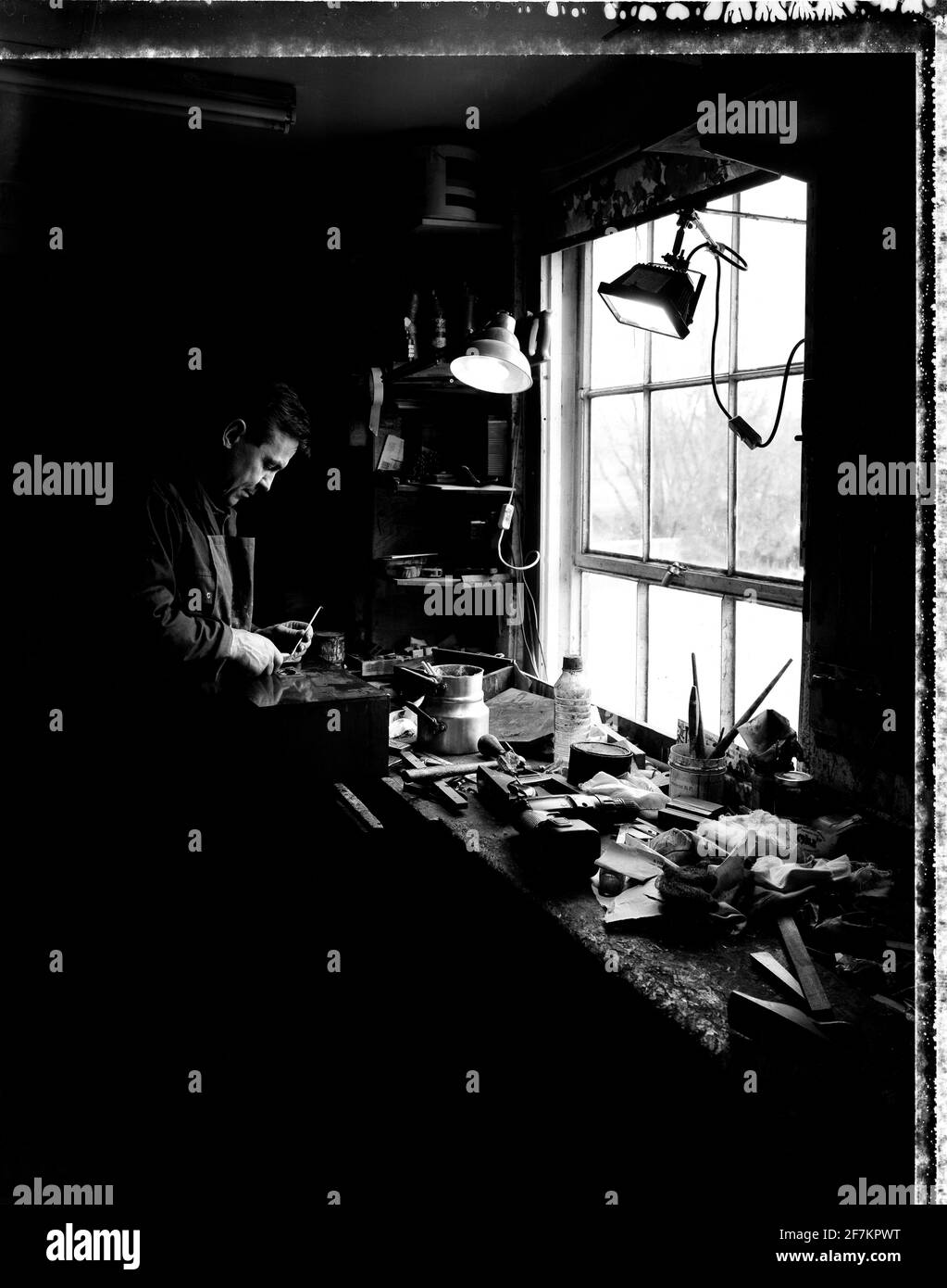 Black and white of a carpenter at work with tools by a window Stock ...