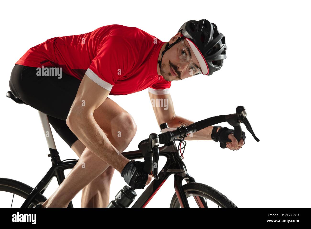 Young professional male bike rider on road bike isolated over white ...
