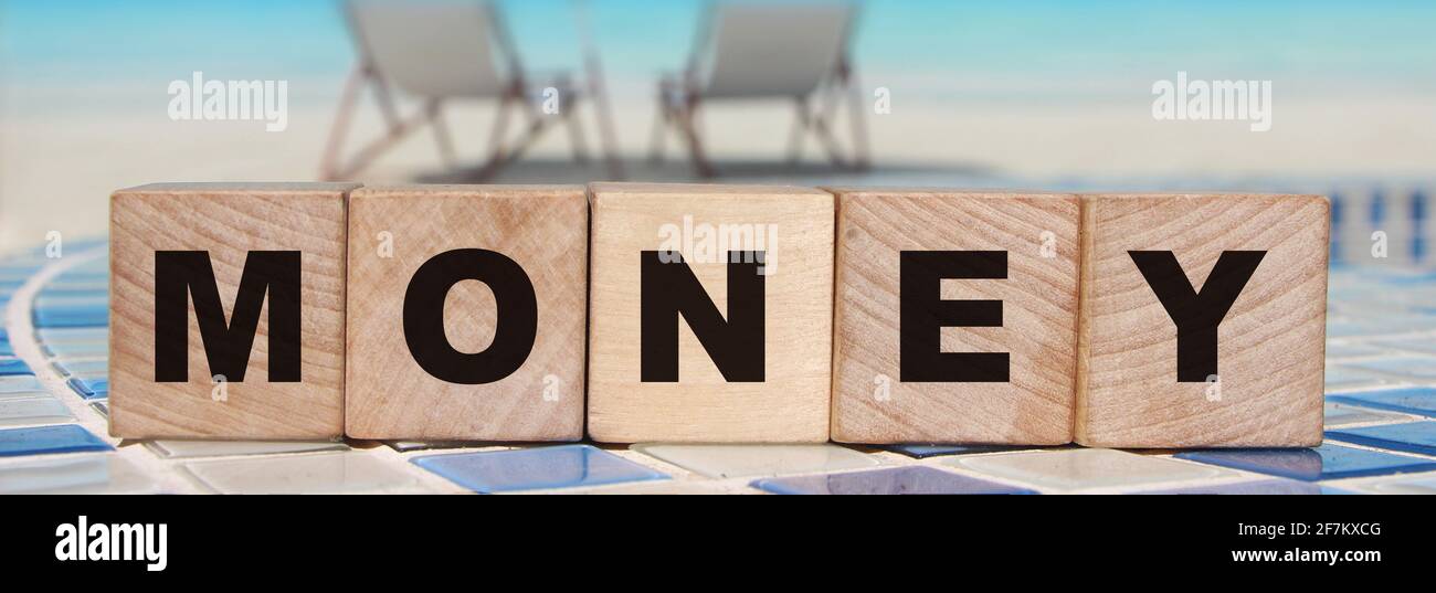 Wooden blocks with the word Money and a pile of coins, Money climbing ...