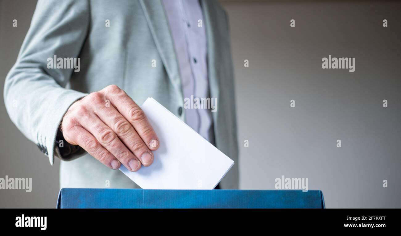 male hand putting vote in ballot Stock Photo - Alamy