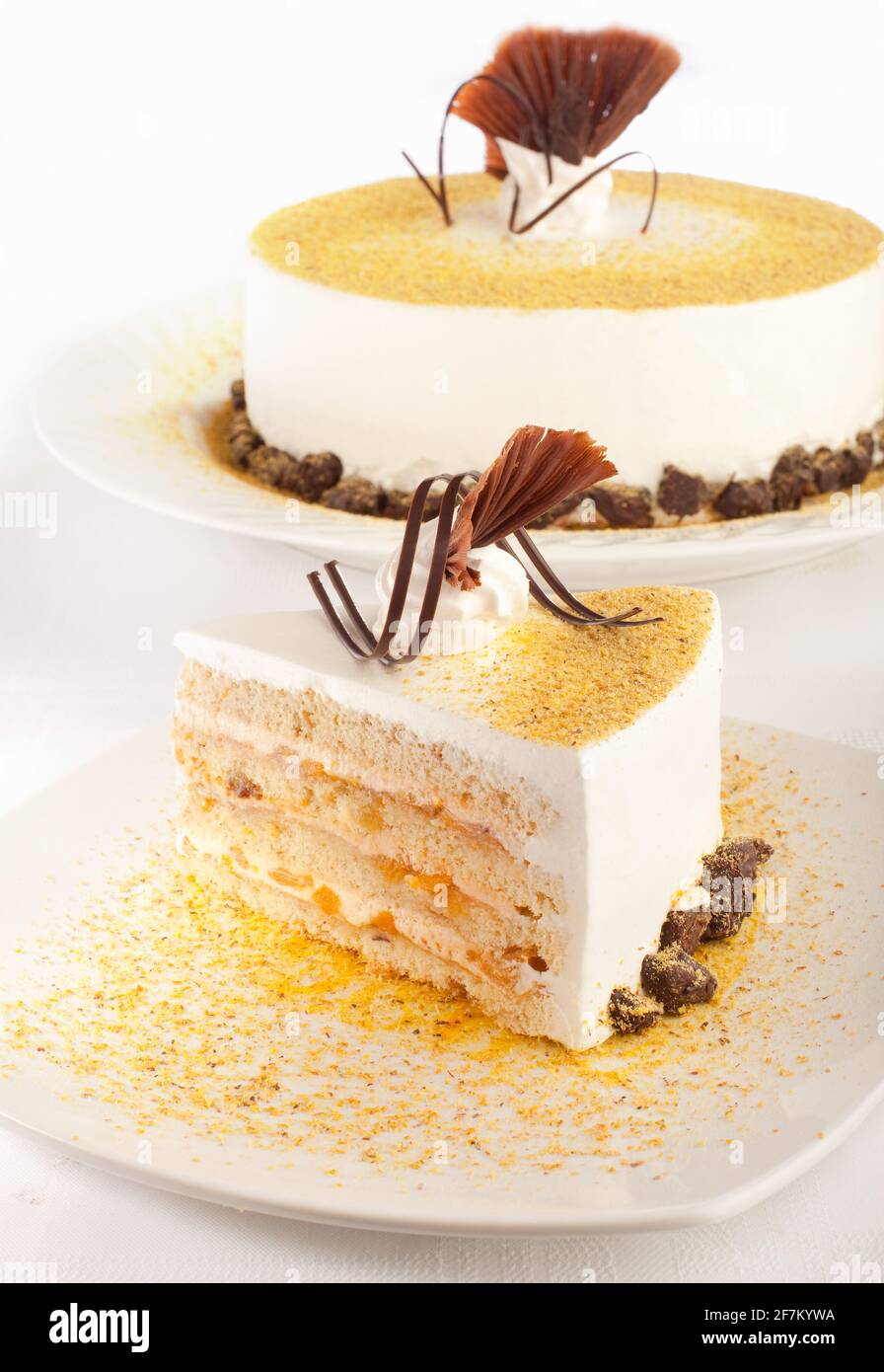 A styled cake and a piece of that cake in front of it Stock Photo - Alamy