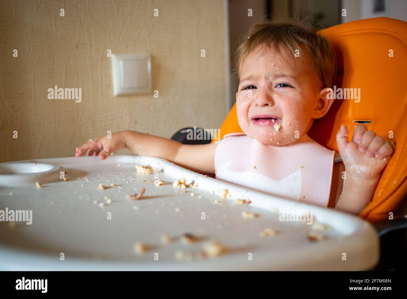 portrait of cute crying baby toddler sitting with dining table Stock ...