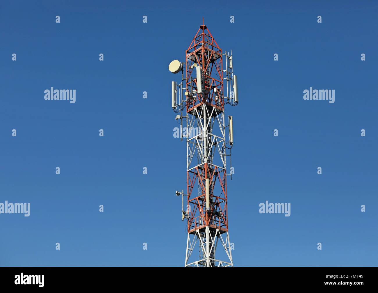 Cellular, mobile phone transmitter tower and weather station with blue sky Stock Photo - Alamy