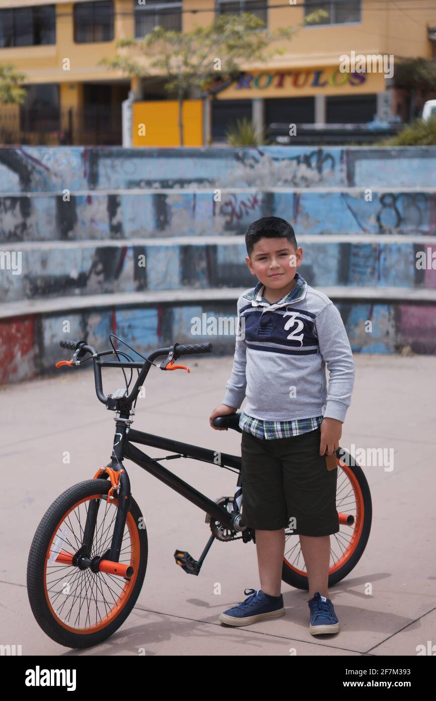 Boy riding his bike through the park enjoying the fresh air Stock Photo ...