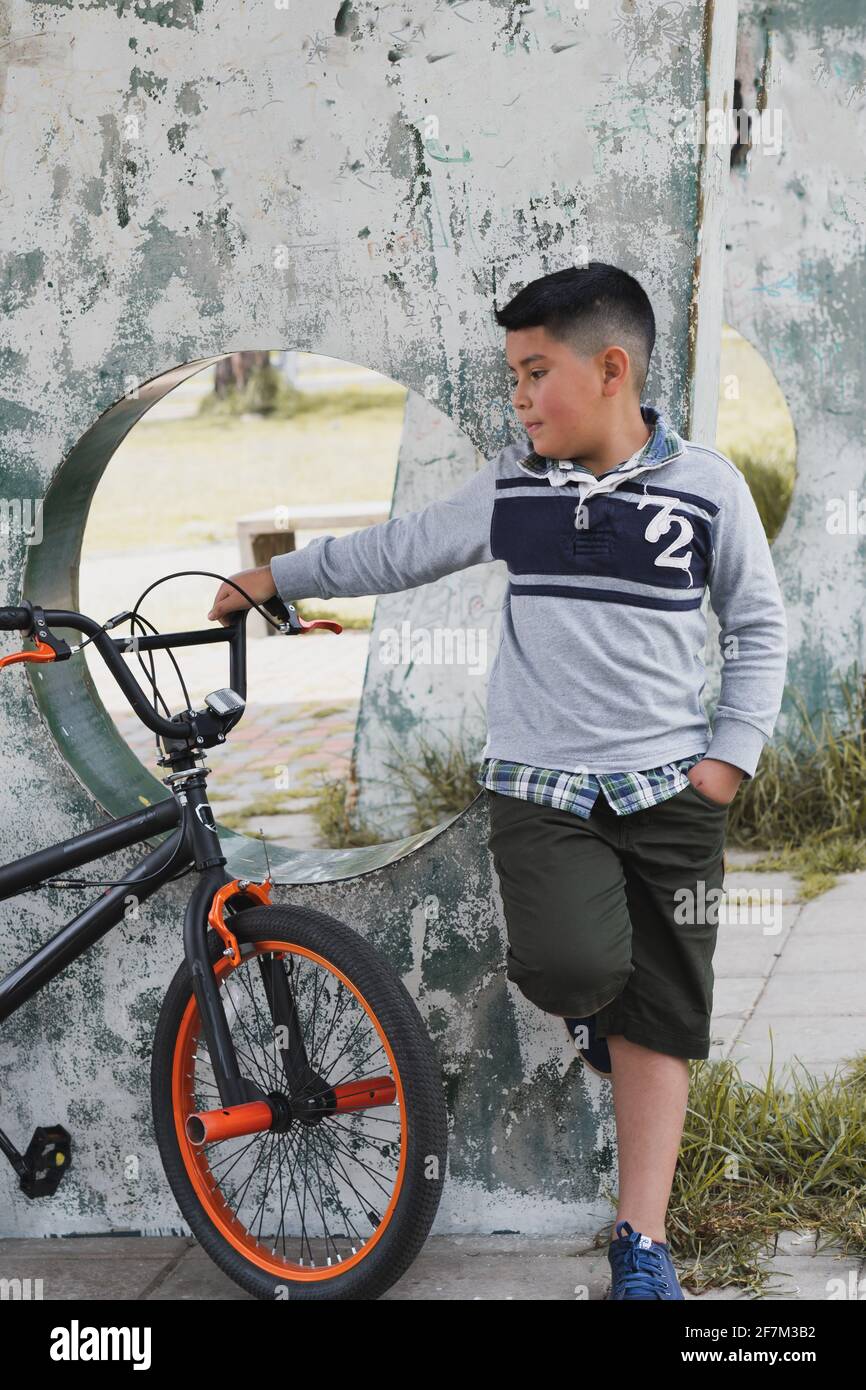 Boy riding his bike through the park enjoying the fresh air Stock Photo ...