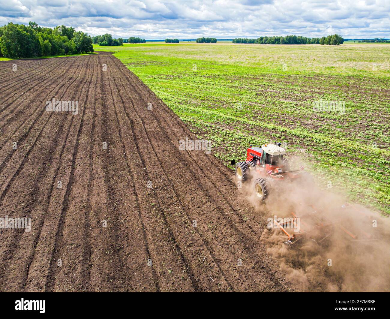Aerial view drone of harvest field with tractor mows dry grass. Autumn ...