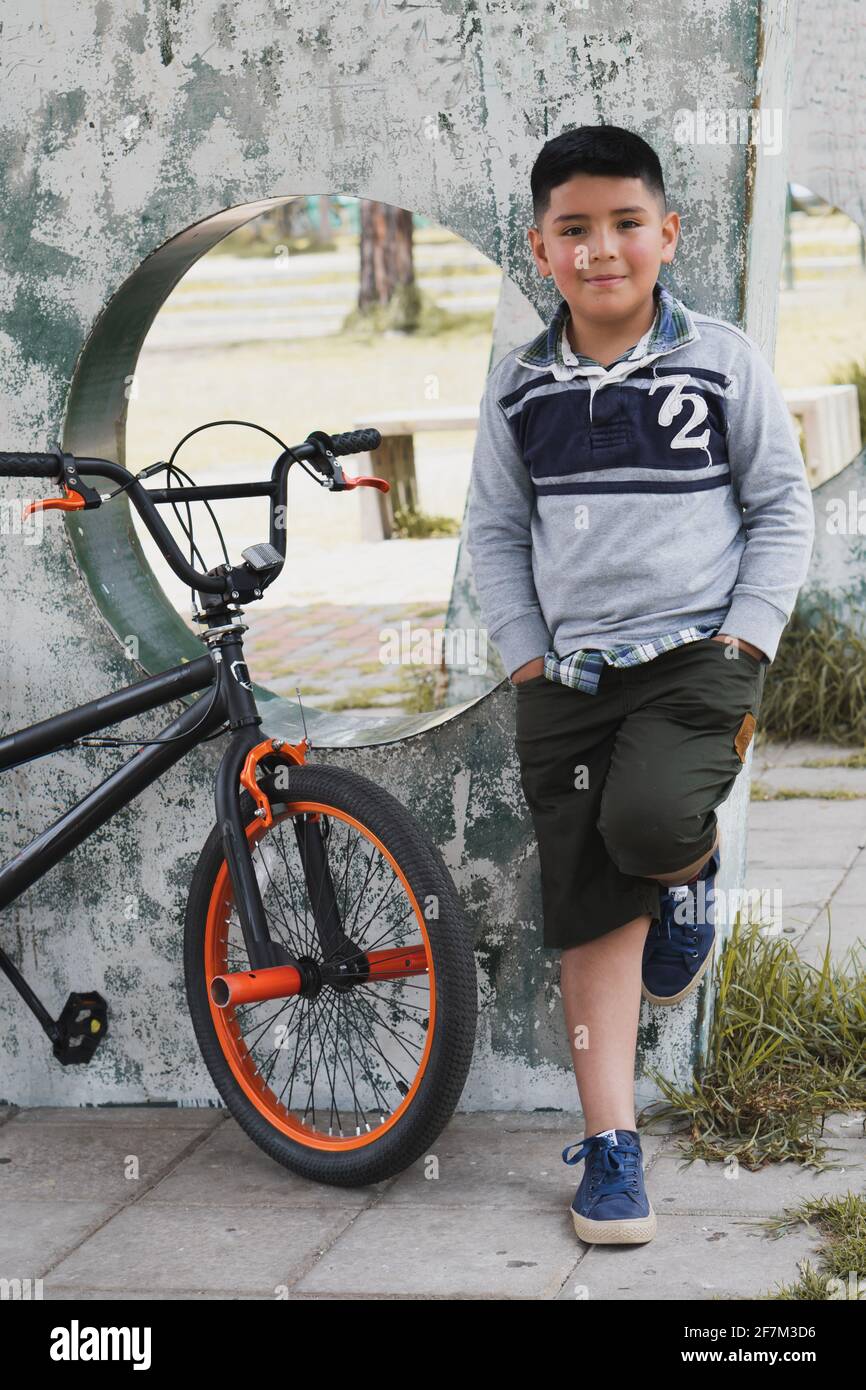Boy riding his bike through the park enjoying the fresh air Stock Photo ...