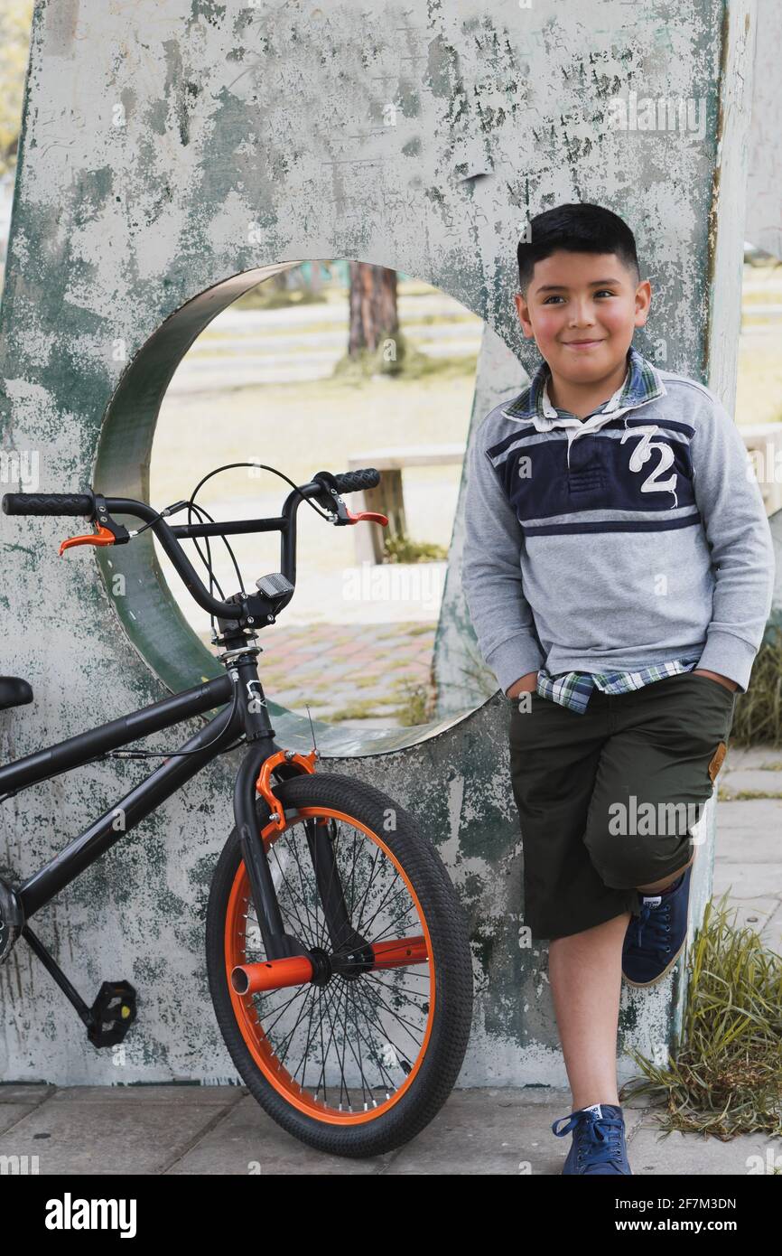 Boy riding his bike through the park enjoying the fresh air Stock Photo ...