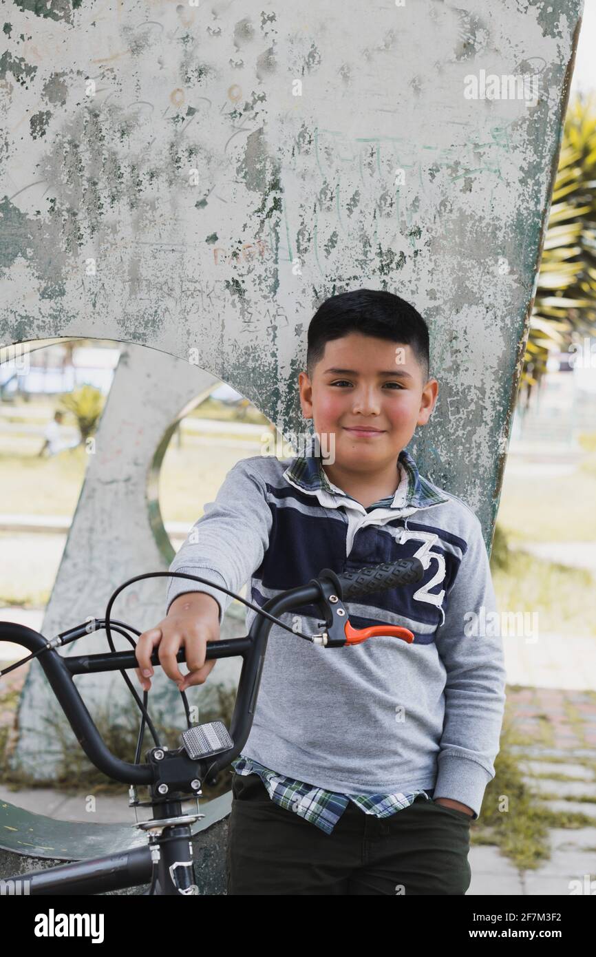 Boy riding his bike through the park enjoying the fresh air Stock Photo ...