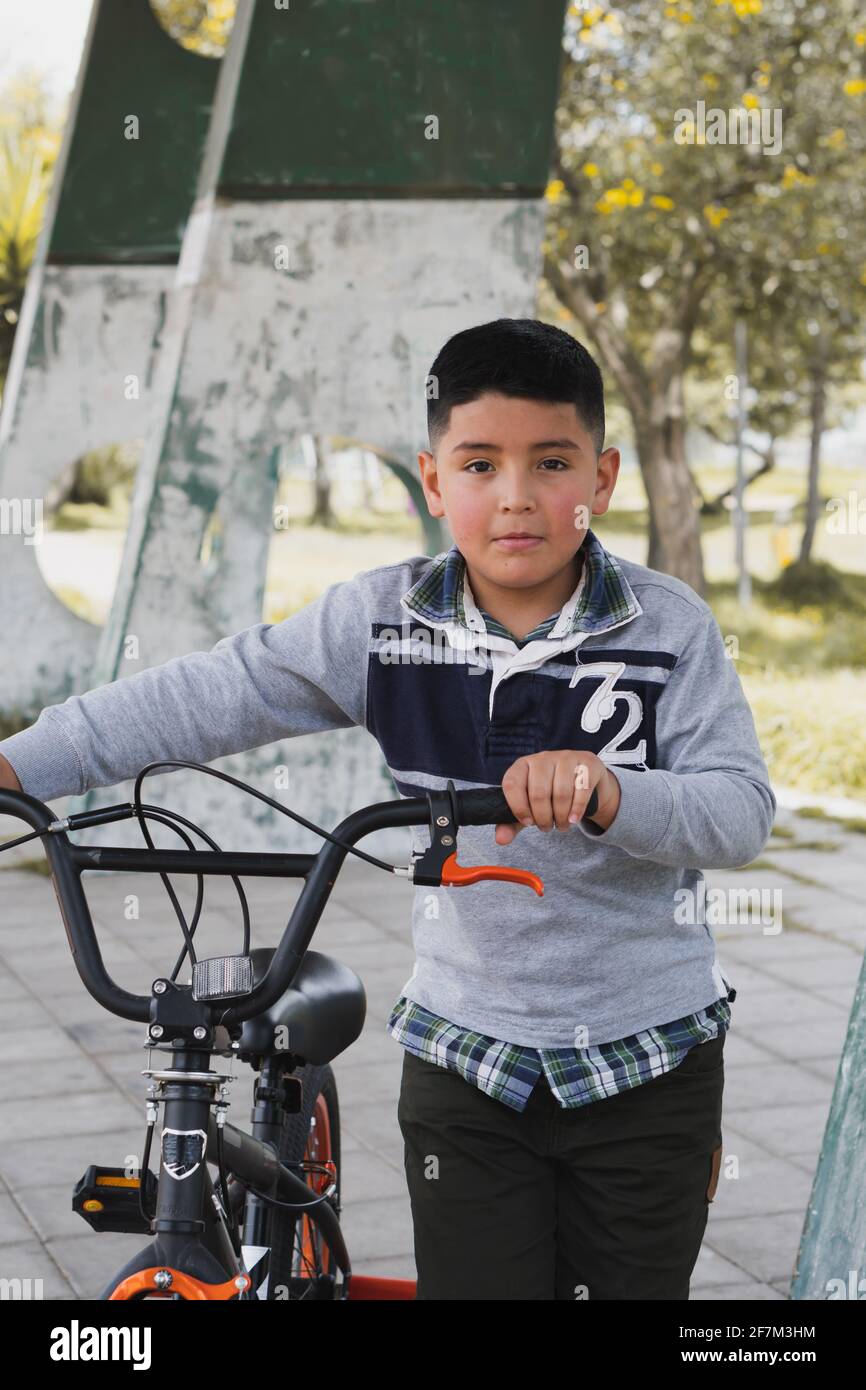 Boy riding his bike through the park enjoying the fresh air Stock Photo ...