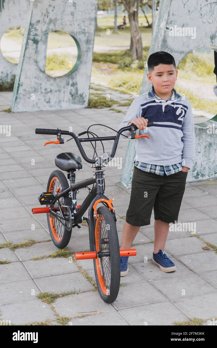 Boy riding his bike through the park enjoying the fresh air Stock Photo ...