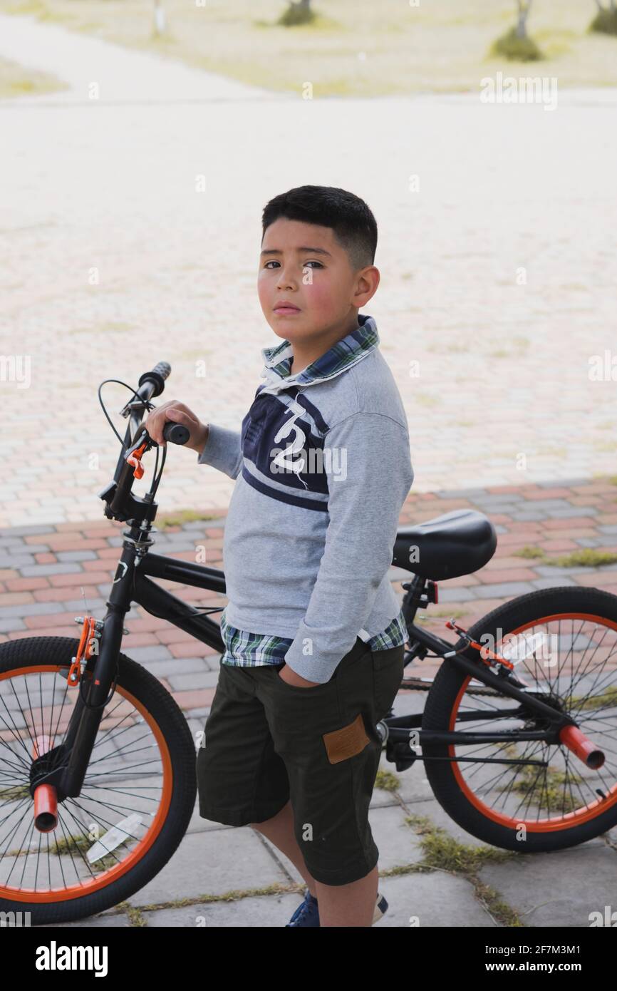 Boy riding his bike through the park enjoying the fresh air Stock Photo ...