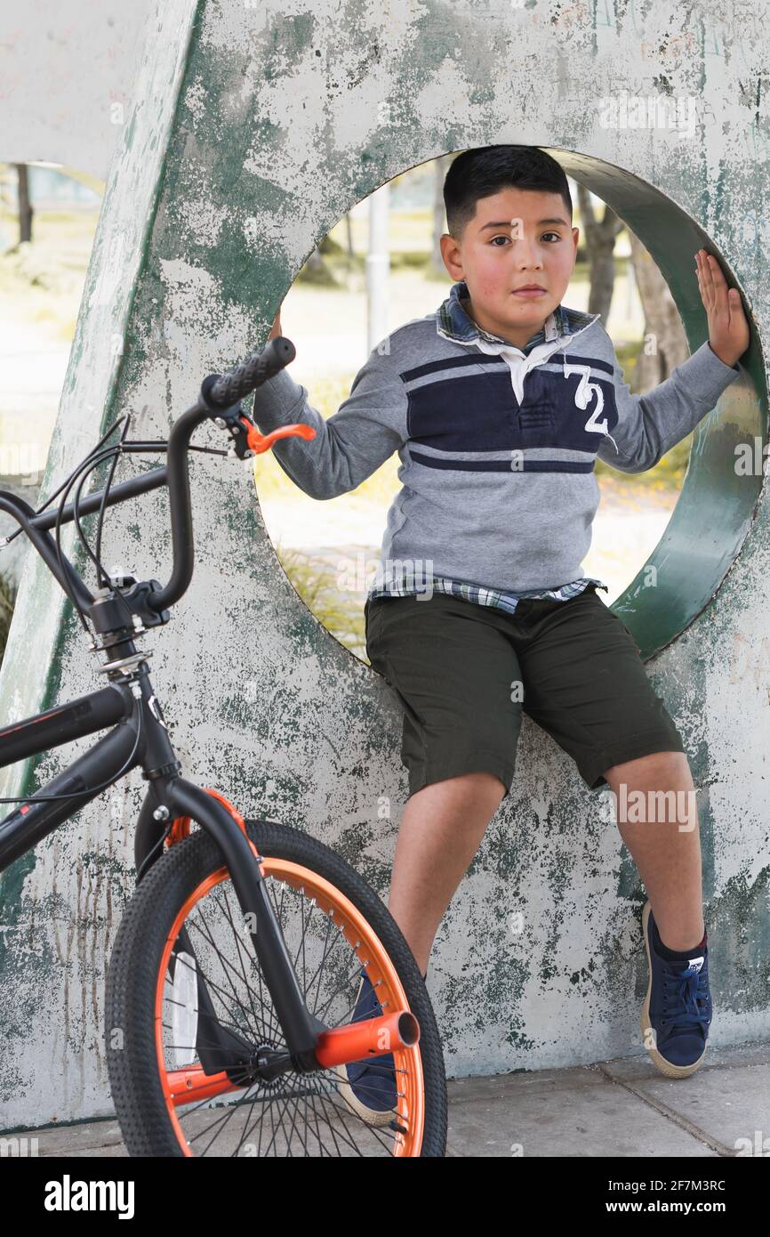 Boy riding his bike through the park enjoying the fresh air Stock Photo ...