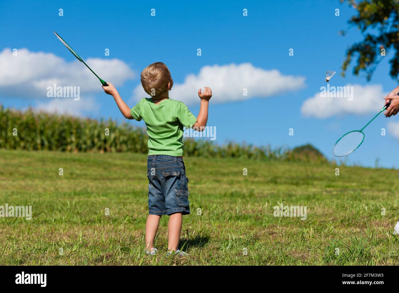 Family - little boy playing badminton outdoors on a summer day Stock ...