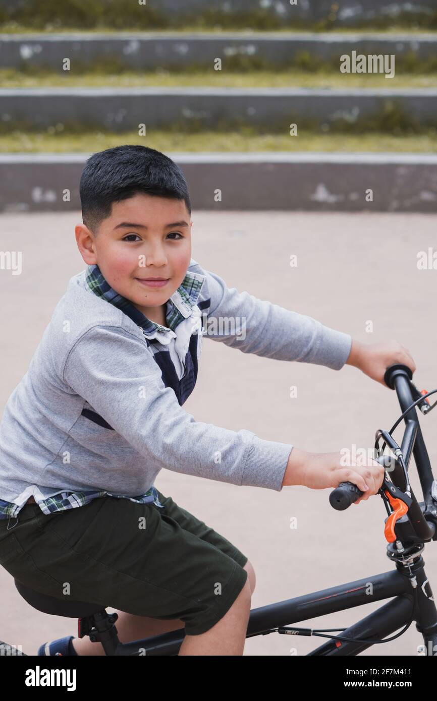 Boy riding his bike through the park enjoying the fresh air Stock Photo ...