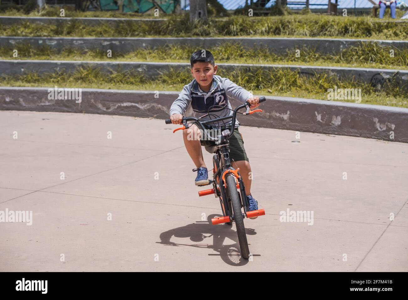 Boy riding his bike through the park enjoying the fresh air Stock Photo ...