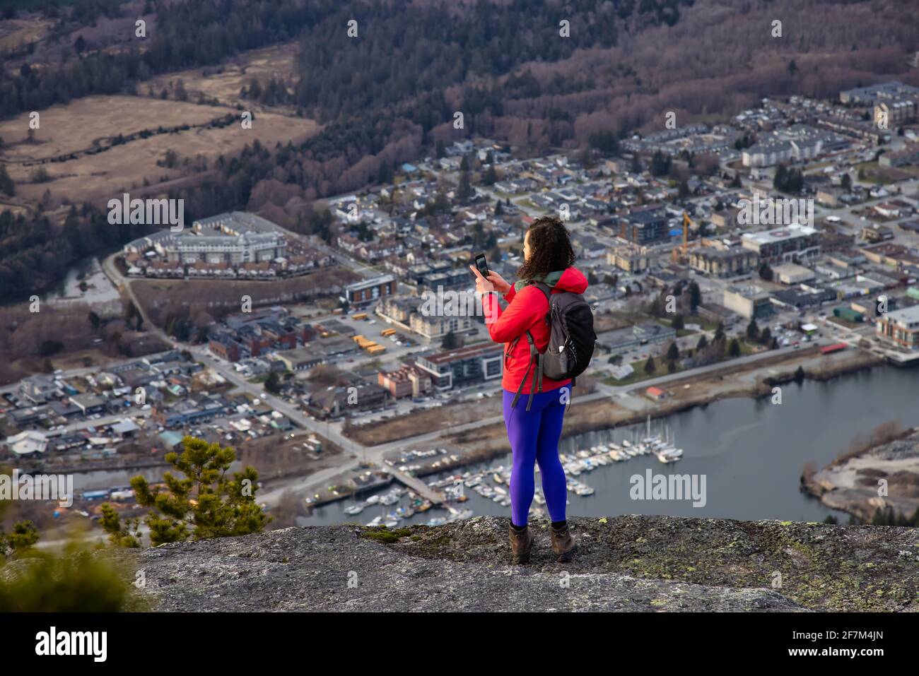 Adventurous Girl Hiking on top of a Peak Stock Photo - Alamy
