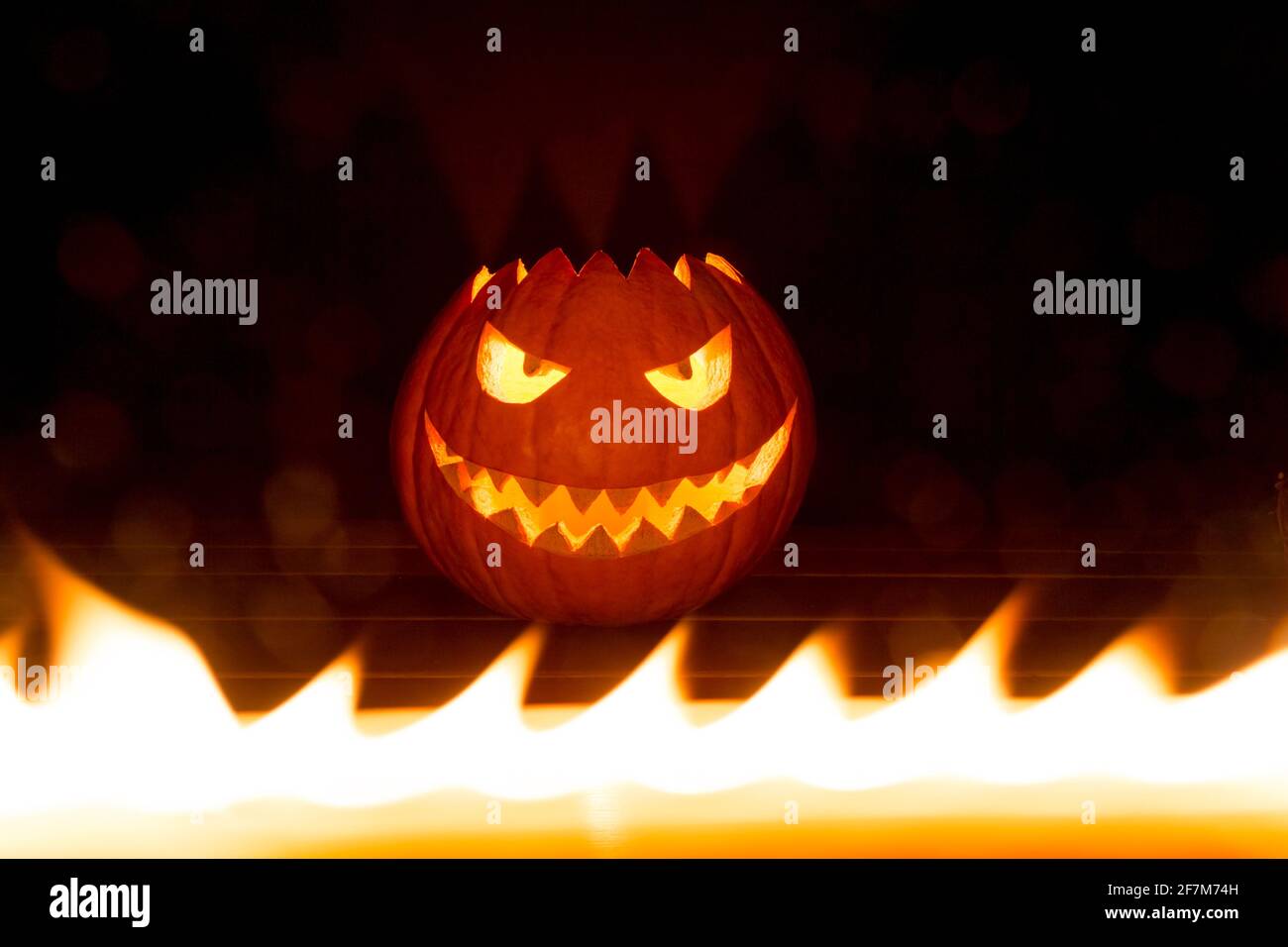 Spooky carved halloween pumpkin in hot burning hell fire flames. Big ...