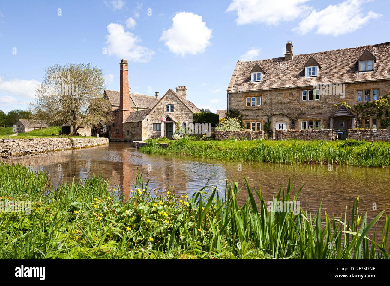 The Old Mill on the River Eye flowing through the Cotswold village of ...