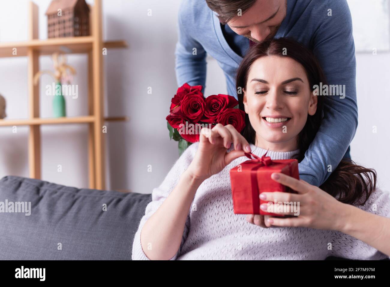 Smiling woman holding present hi-res stock photography and images - Alamy