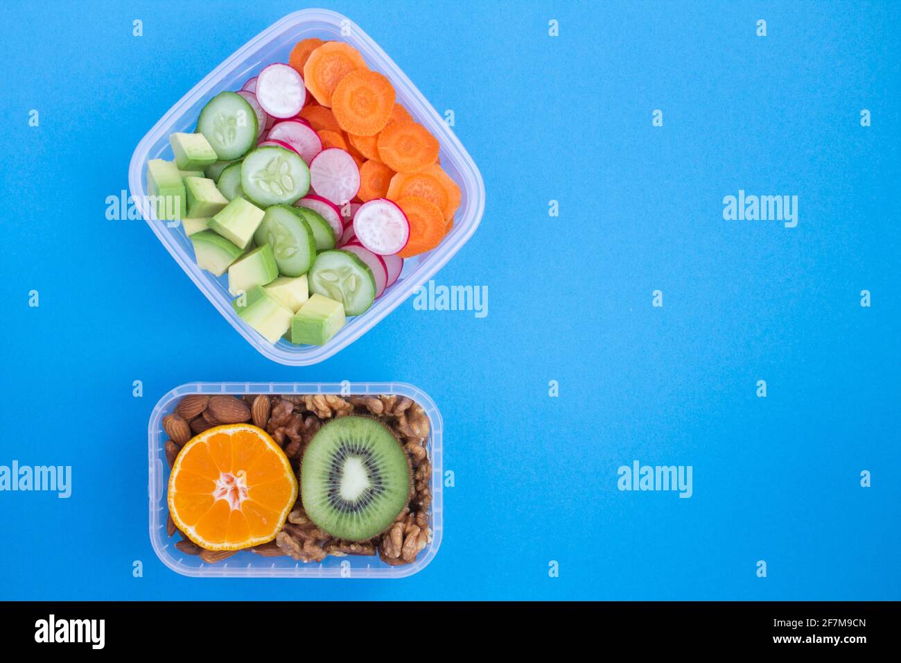 Vegetarian snack or lunch in the two boxes on the blue background. Top ...