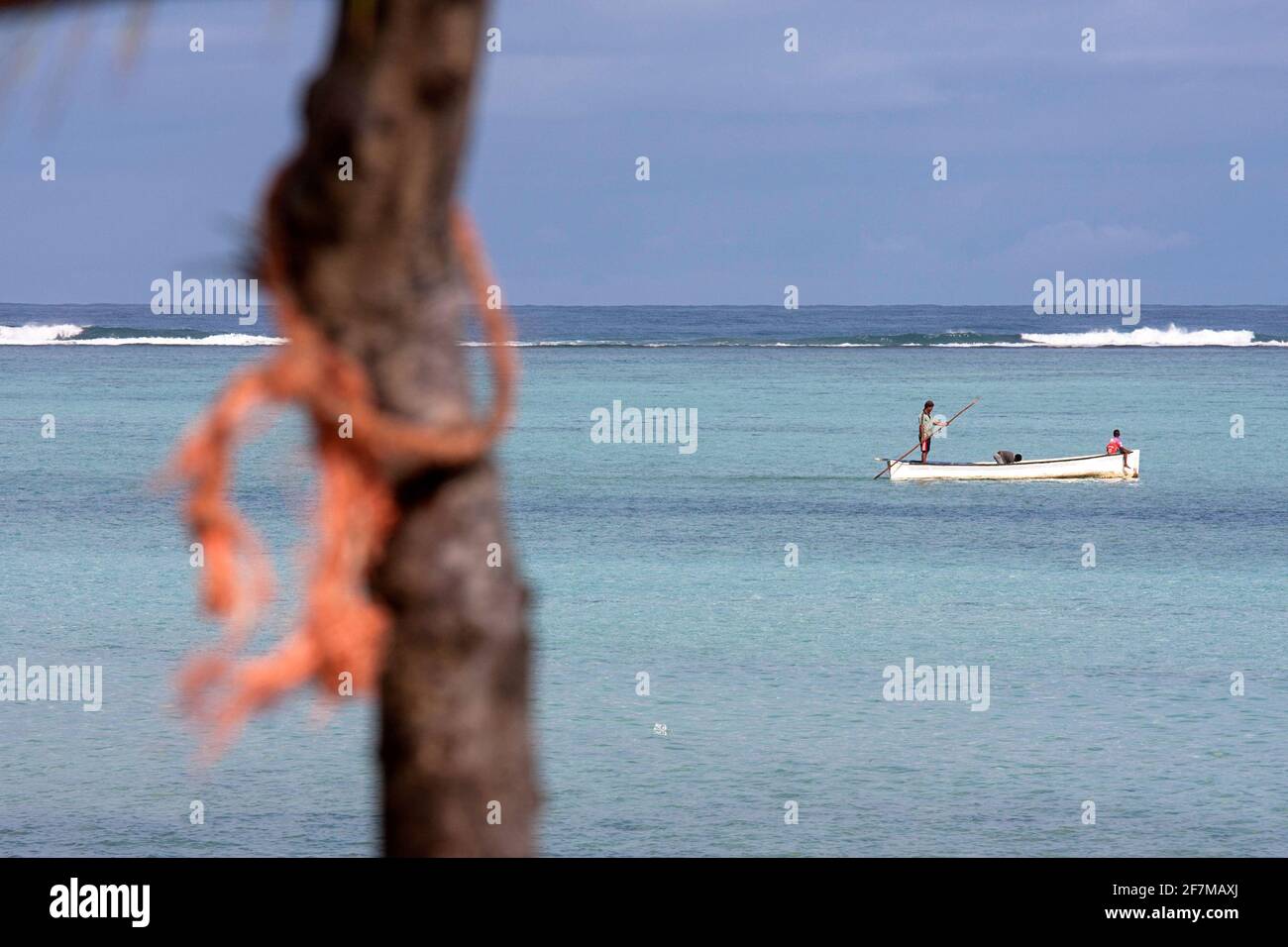 Local fishermen fishing from a traditional wooden fishing boat in a ...