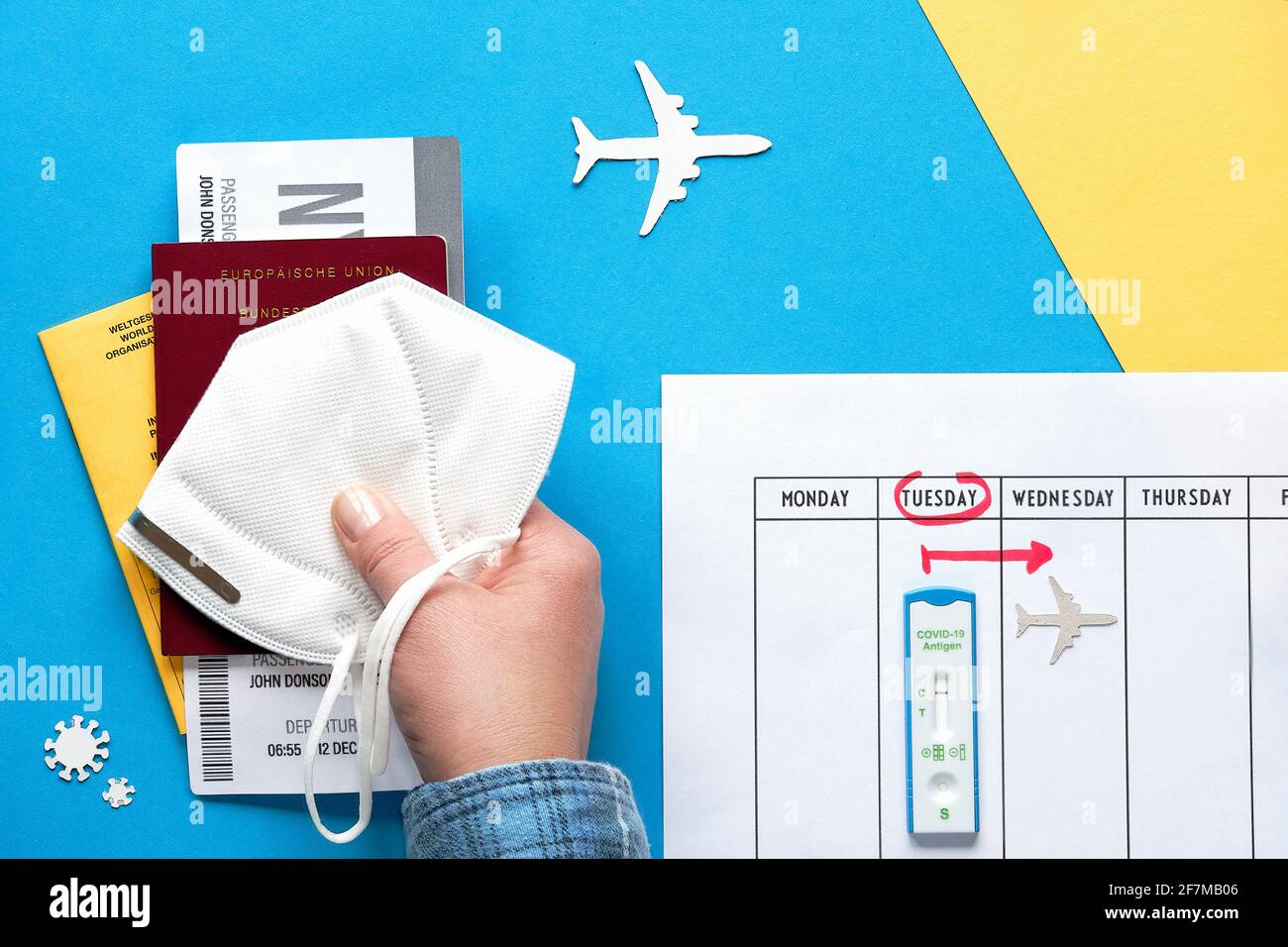 New normal travel during COVID-19 restrictions, flat lay on blue yellow ...