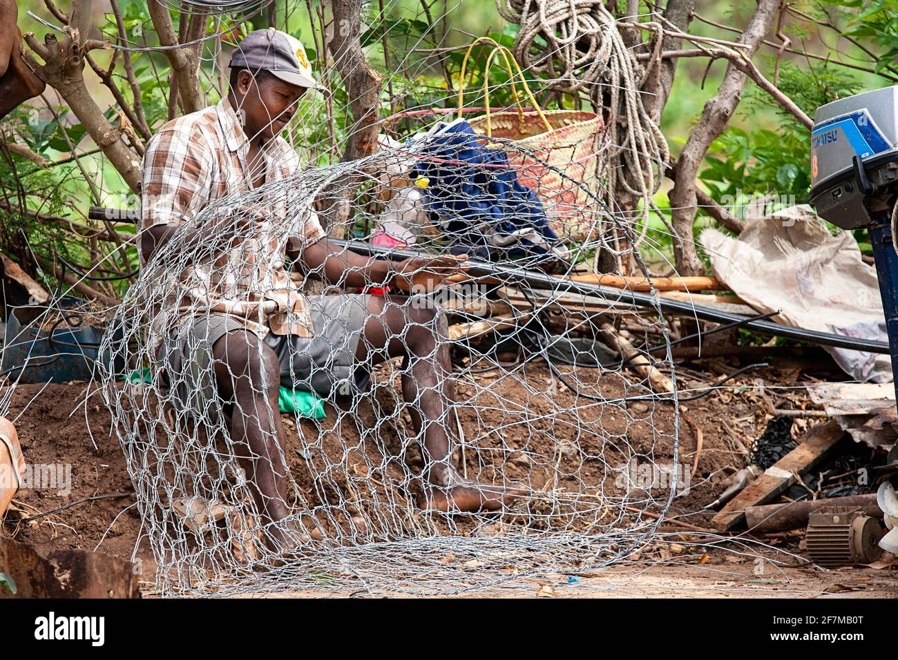 Local fisherman repairing his fishing trap on the beautiful island of ...