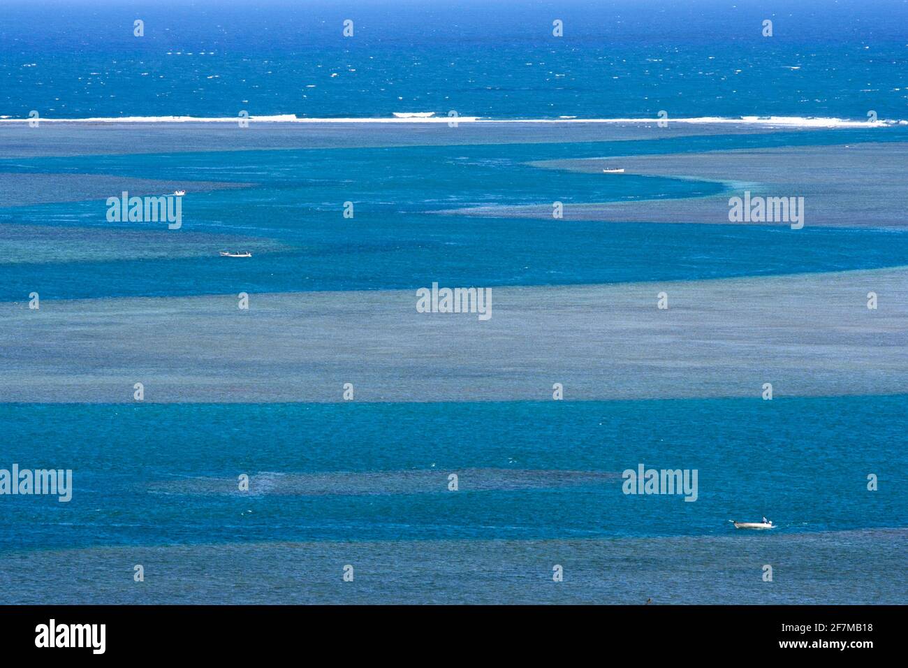 Spectacular view of small fishing boats, coral reef and a passage ...