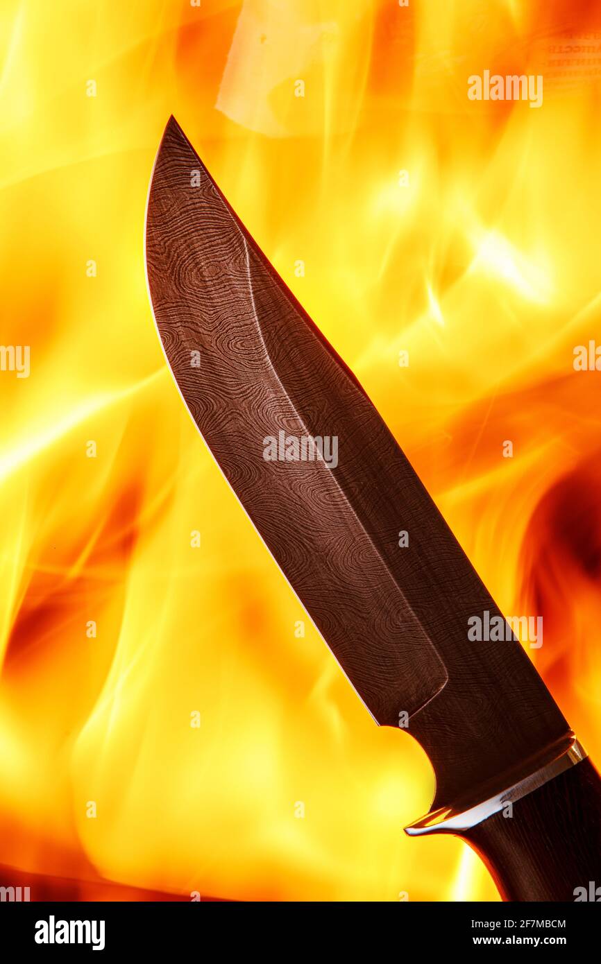 Damascus steel knife on the fire background Stock Photo - Alamy