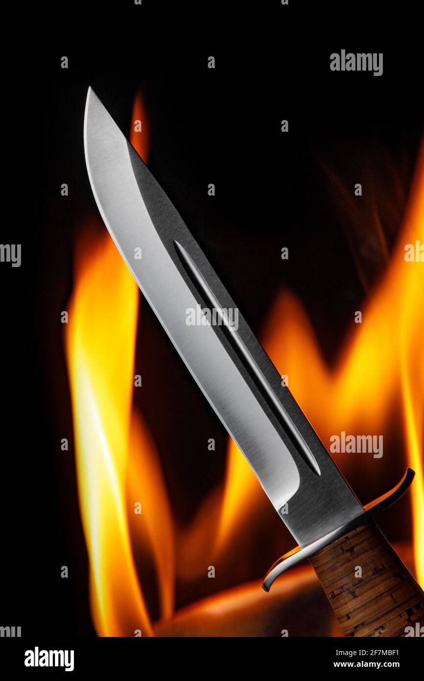 Knife on the fire background Stock Photo - Alamy