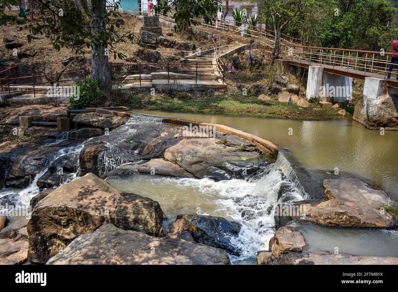 Small water reservoir in stone mountain with bridge for communication ...