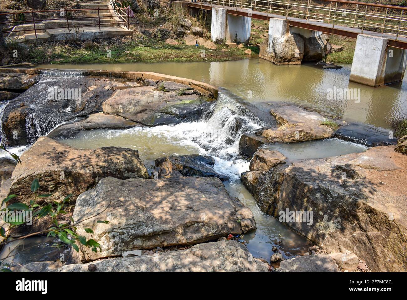 Small water reservoir in stone mountain with bridge for communication ...