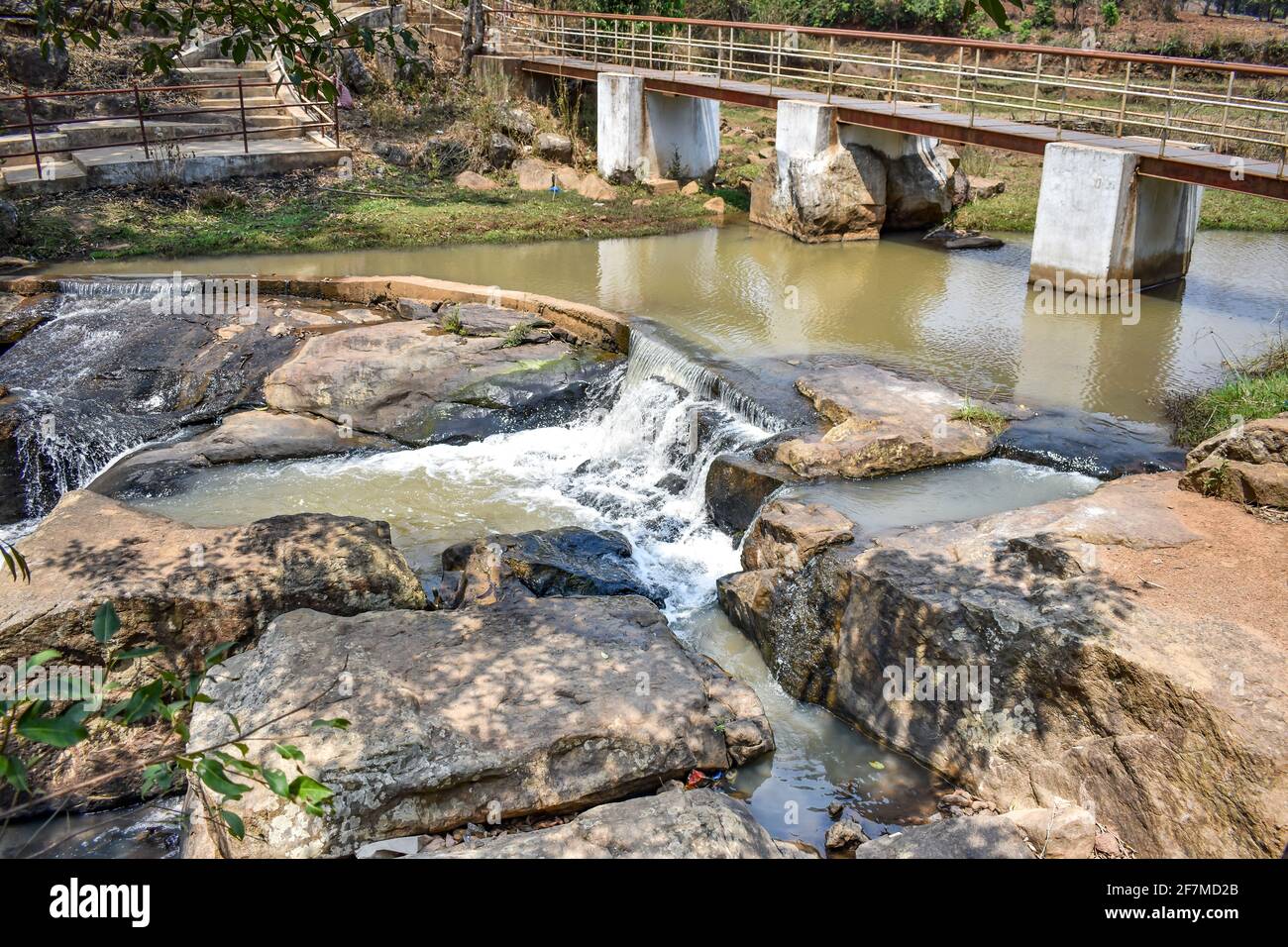 Small water reservoir in stone mountain with bridge for communication ...