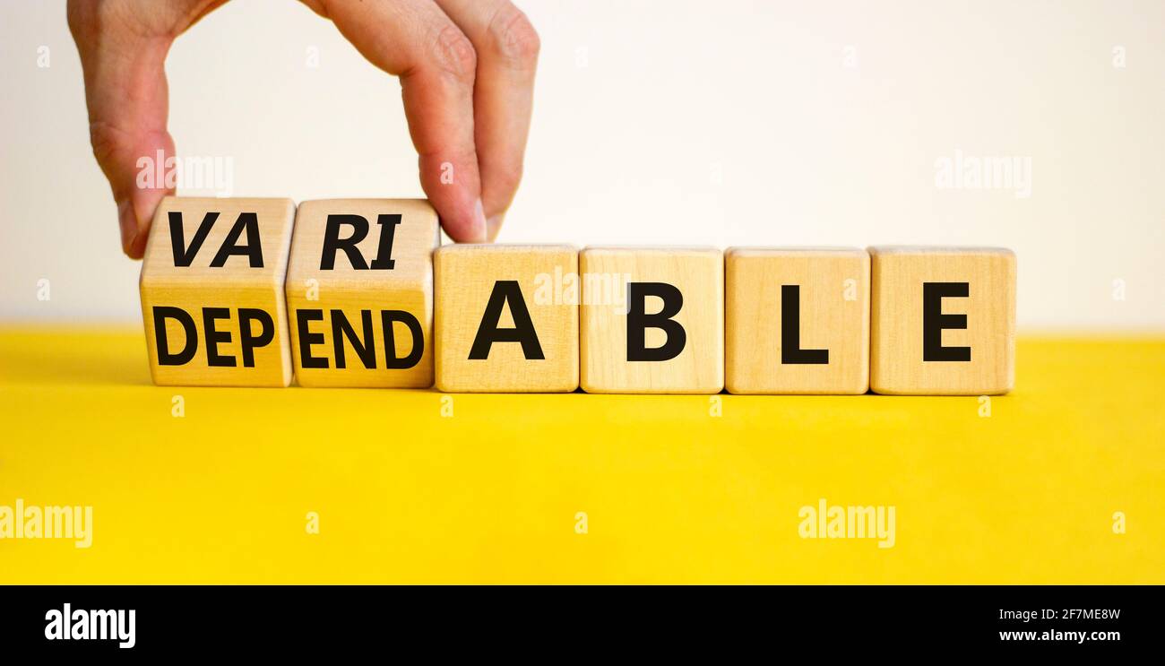 Dependable or variable symbol. Businessman turns wooden cubes and ...