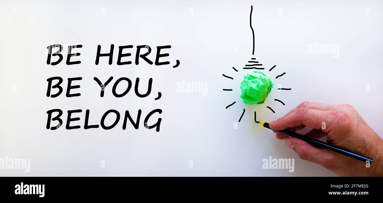 Belonging symbol. Businessman writing words 'be here, be you, belong ...