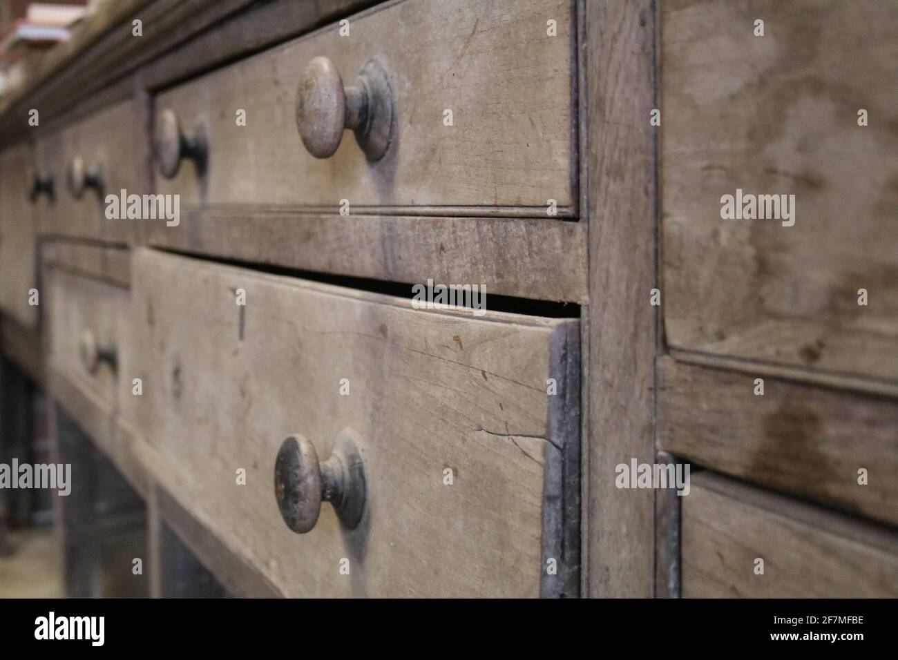side view of wooden draws with round wooden handles, one draw slightly ...