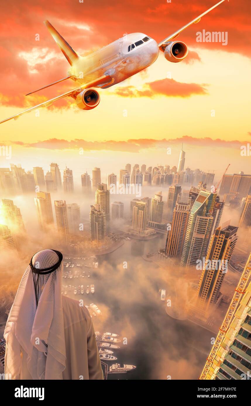 Arabian businessman watching Dubai Marina with Plane flying against ...