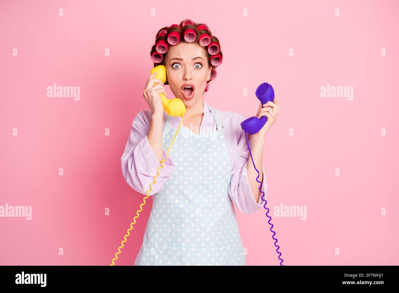 Portrait of attractive person hands hold two old phones open mouth ...