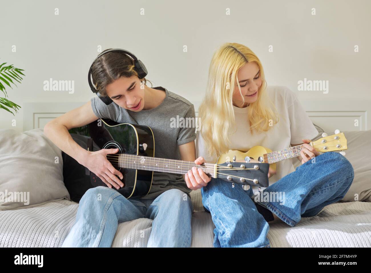 Creative teenagers friends with musical instruments, acoustic guitar ...