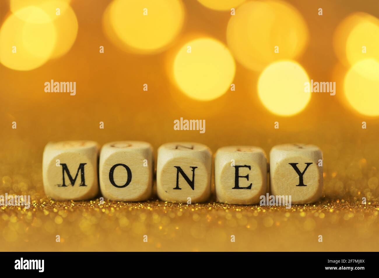 Money concept. Inscription money wooden letters on a gold glitter ...