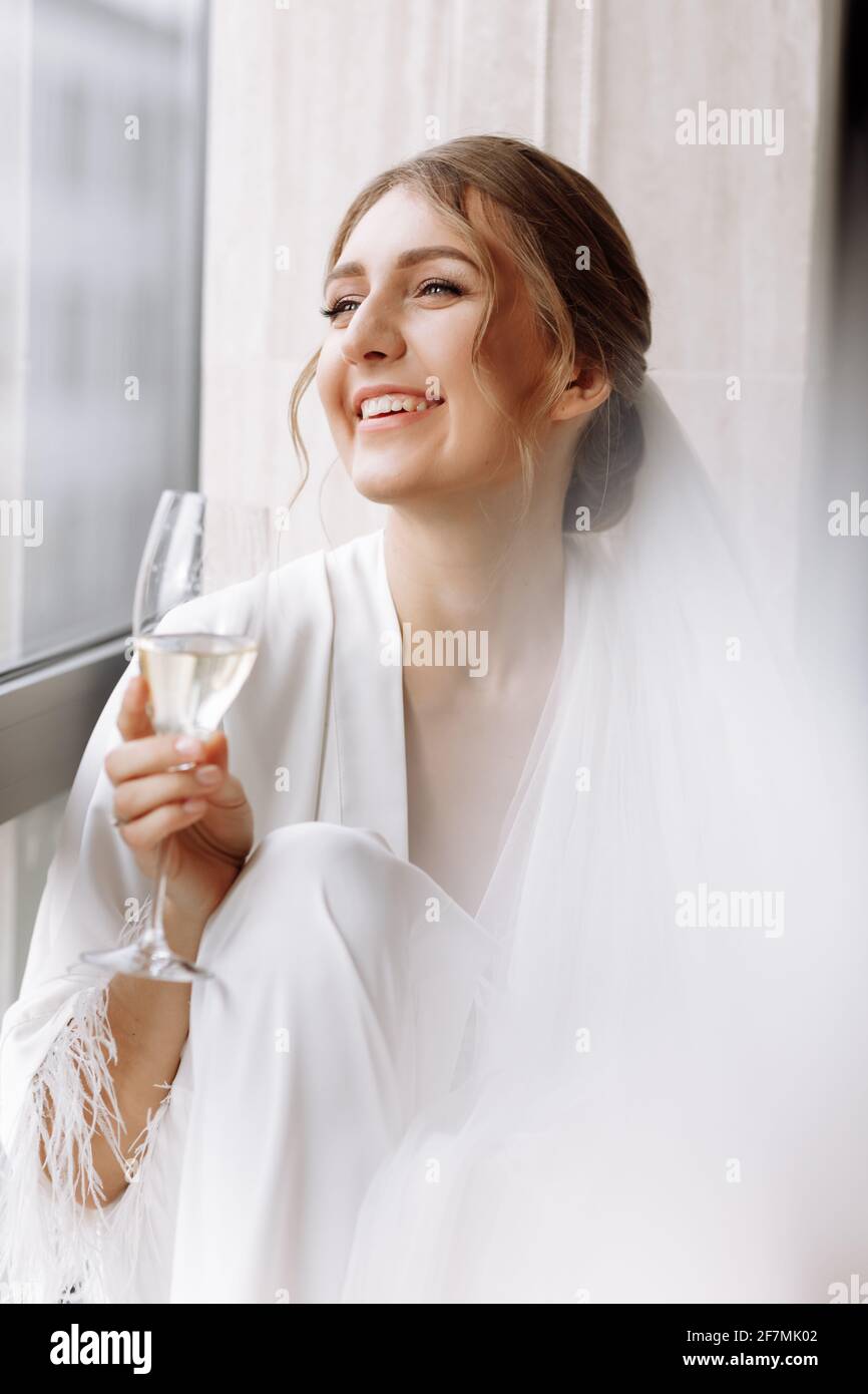 Bride s morning. Bride drinking champagne in the peignoir. young woman ...