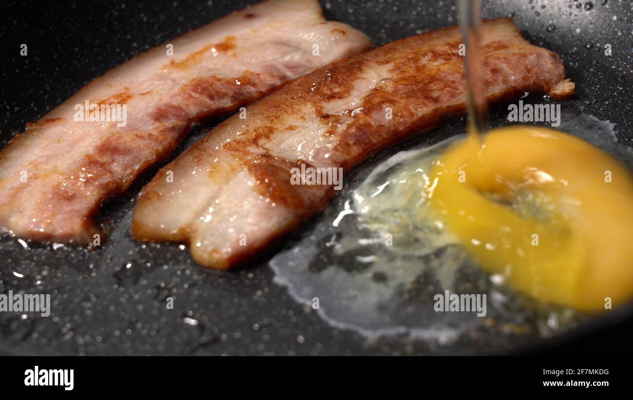 Preparing breakfast frying bacon close hi-res stock photography and ...
