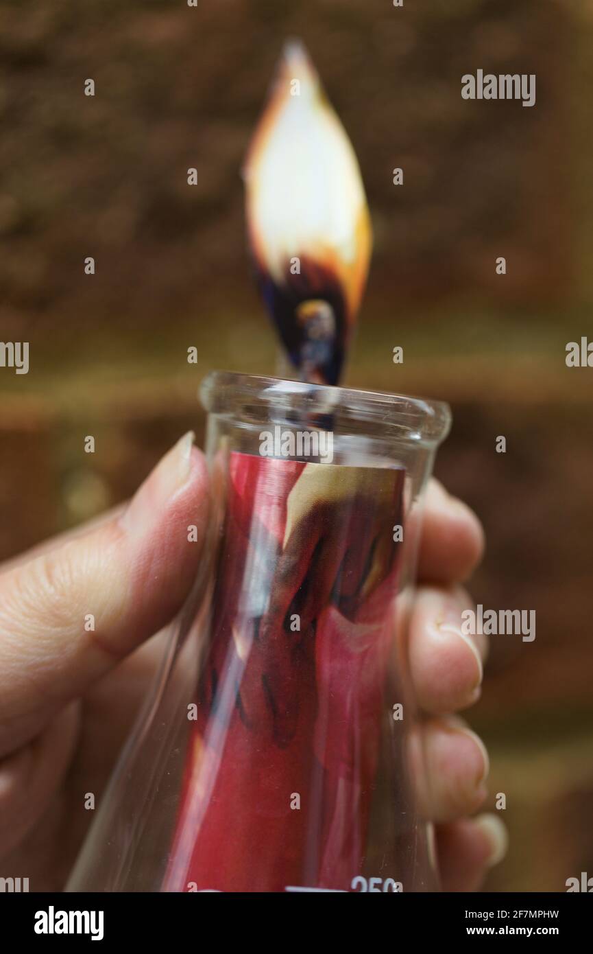 Concept - flames, candle, too hot to handle - Close-up of a hand ...