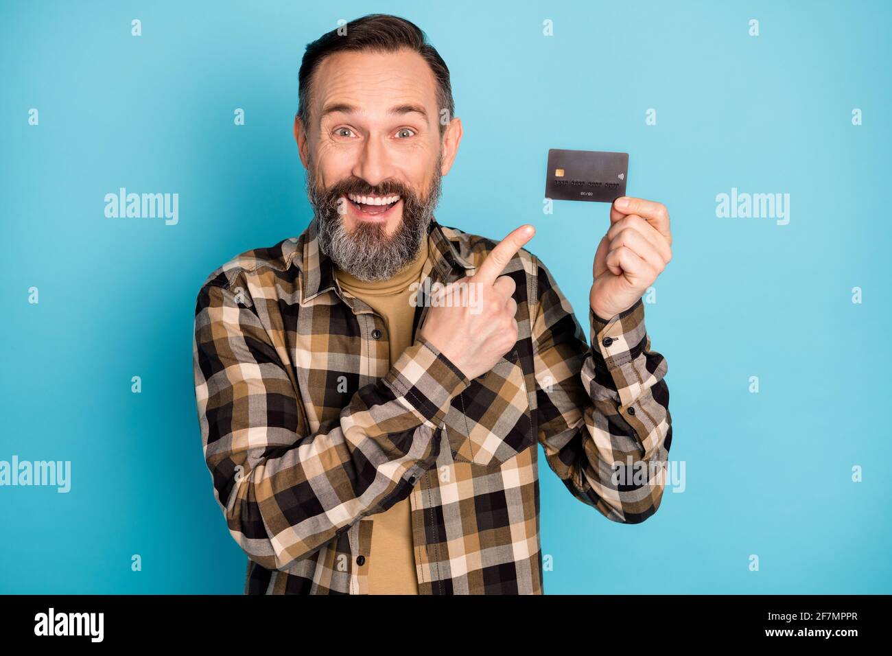 Photo portrait of aged man pointing finger bank card smiling ...
