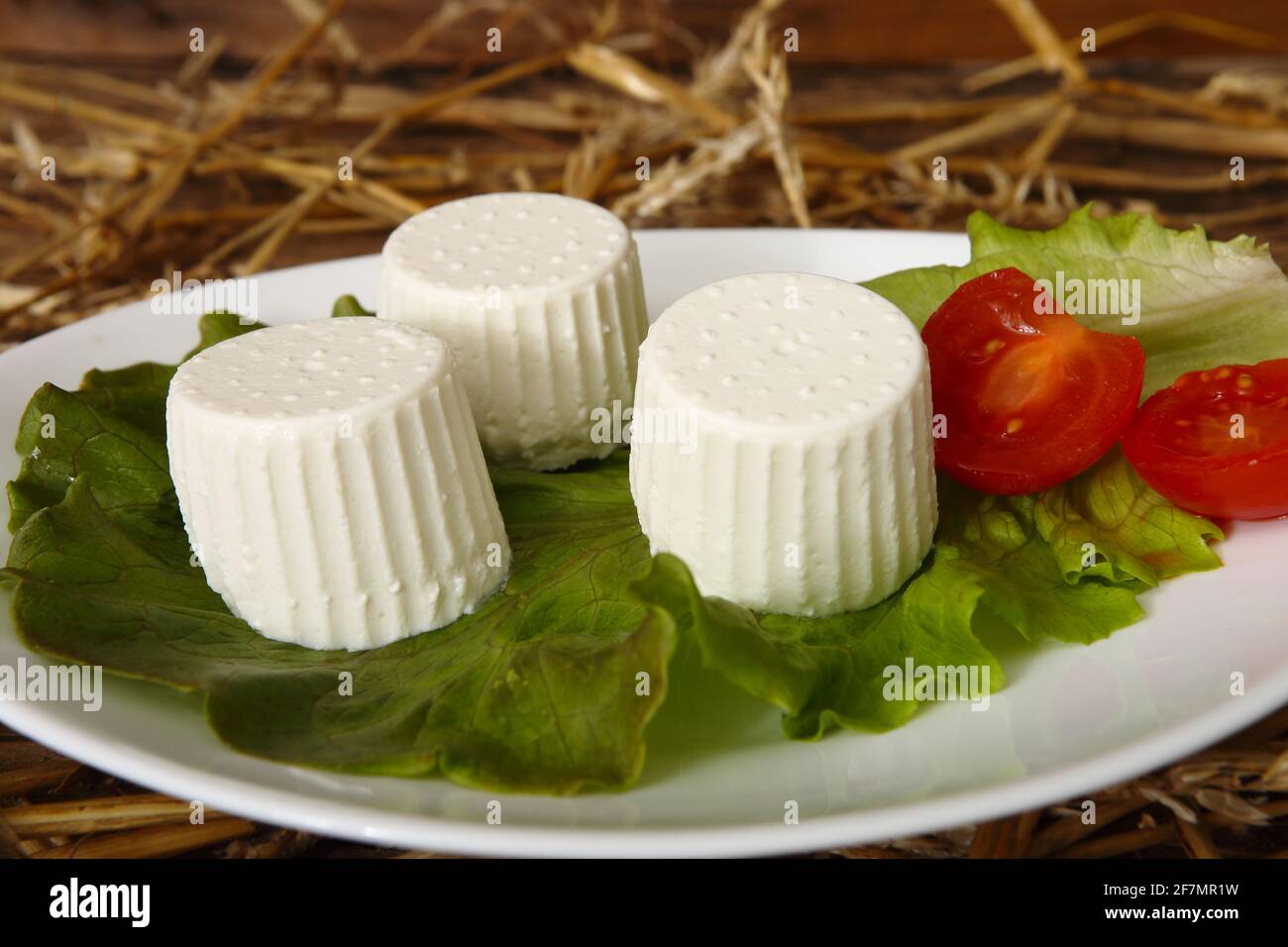 Italian cheese - goat's milk ricotta placed on a sheet of salad leaves ...