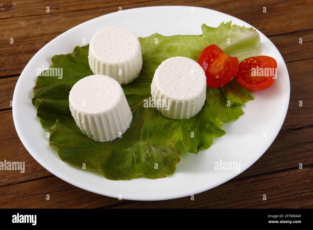 Italian cheese - goat's milk ricotta placed on a sheet of salad leaves ...
