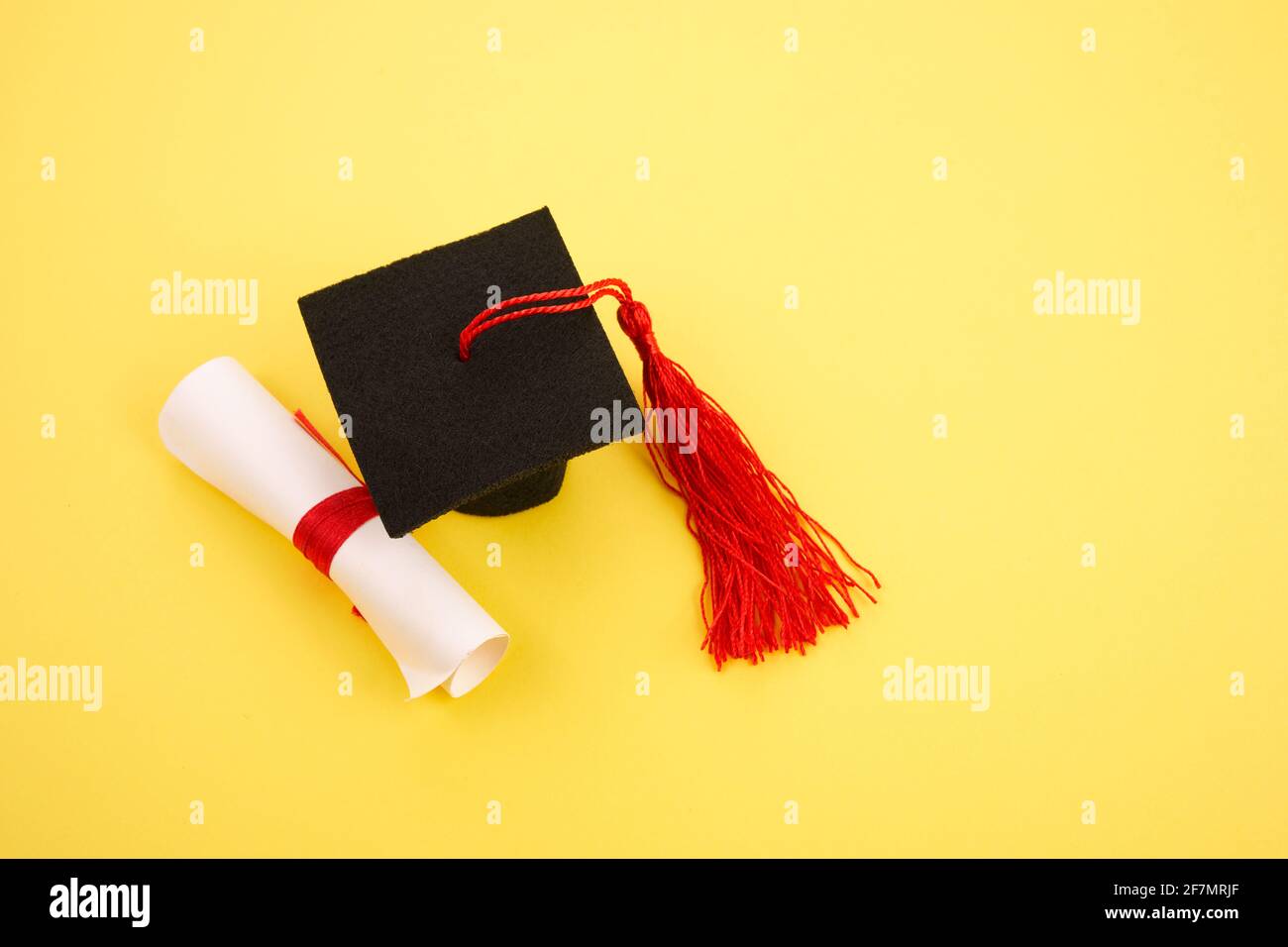 Academic hat with diploma on yellow background. Graduation theme Stock ...